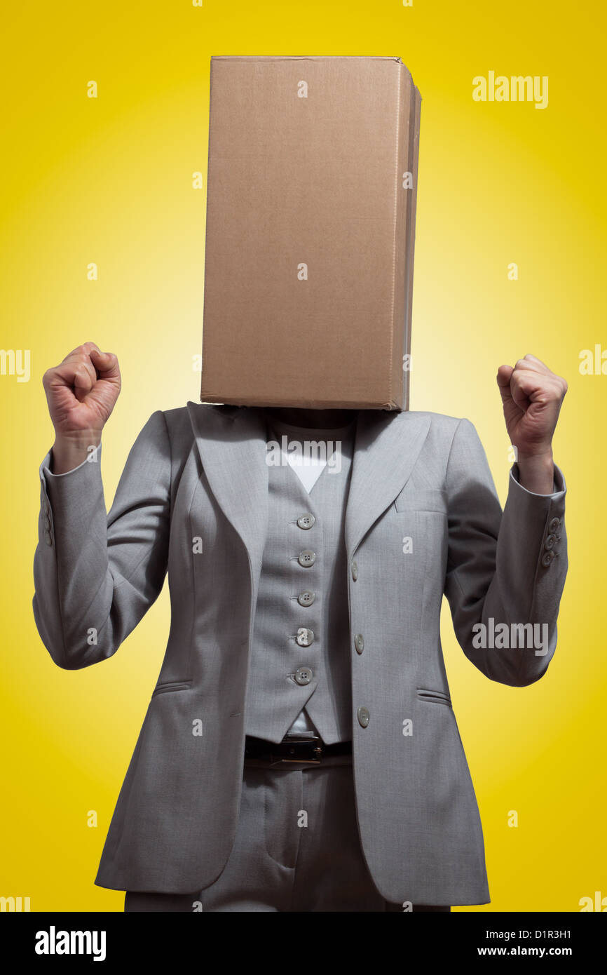 Business woman with a cardboard box head on a yellow background Stock ...