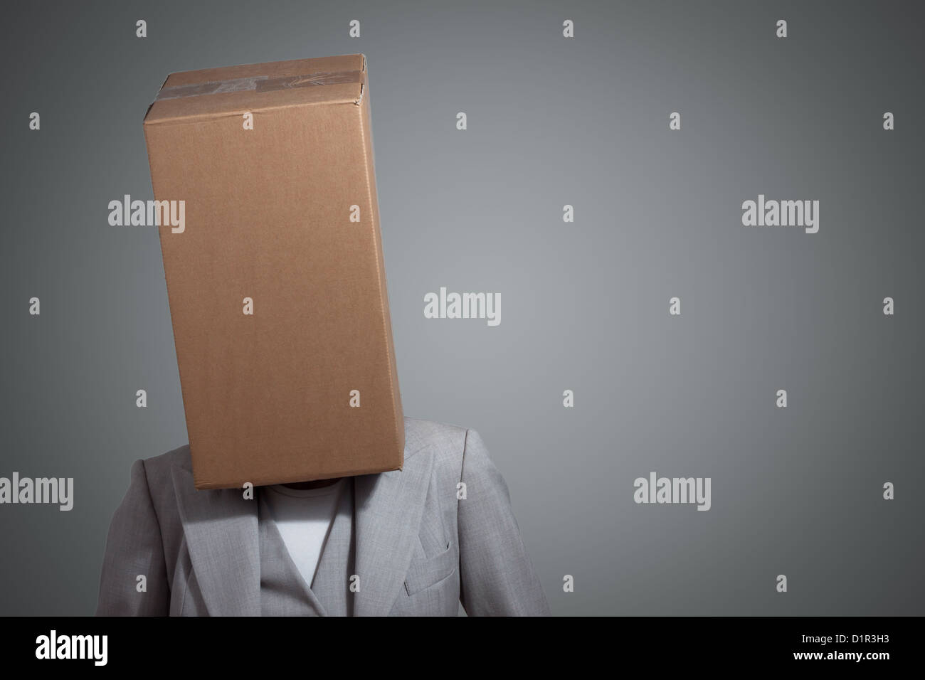 Business woman with a cardboard box head on a gray background Stock ...