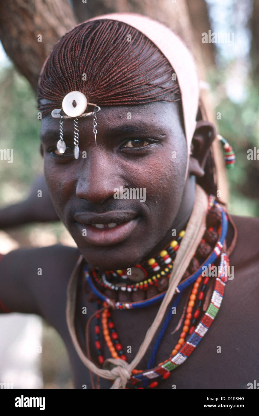 Portrait of Maasai tribesman in traditional clothes, braided hair and ...