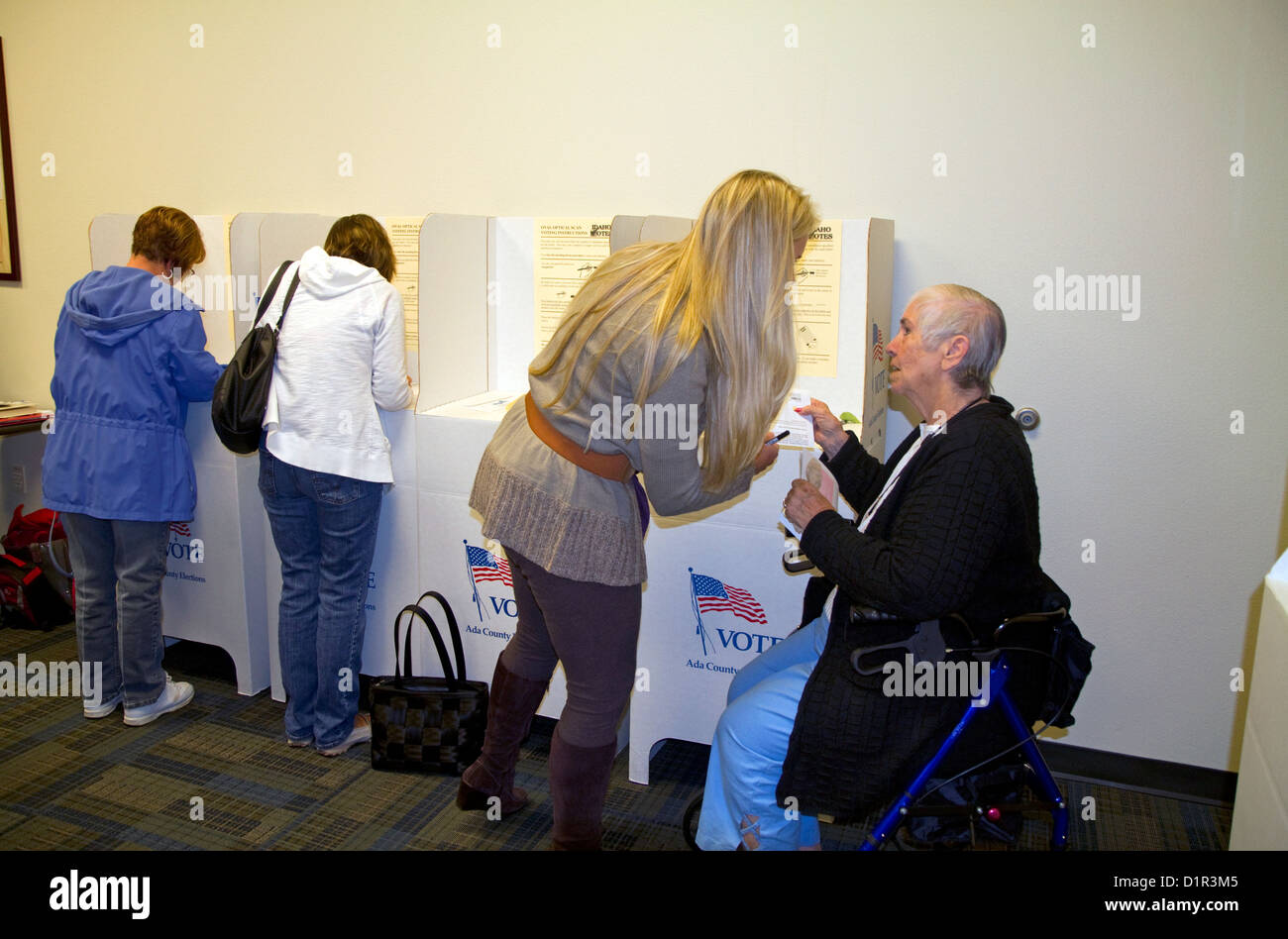 People vote in cardboard voting booths at a polling station in Boise ...