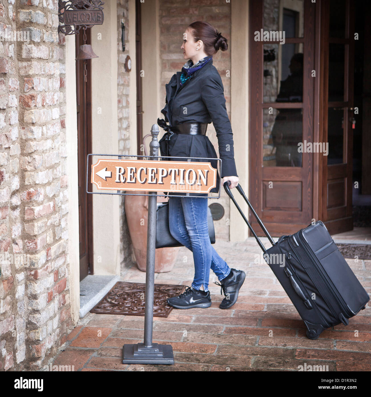 woman at the reception of a hotel Stock Photo - Alamy