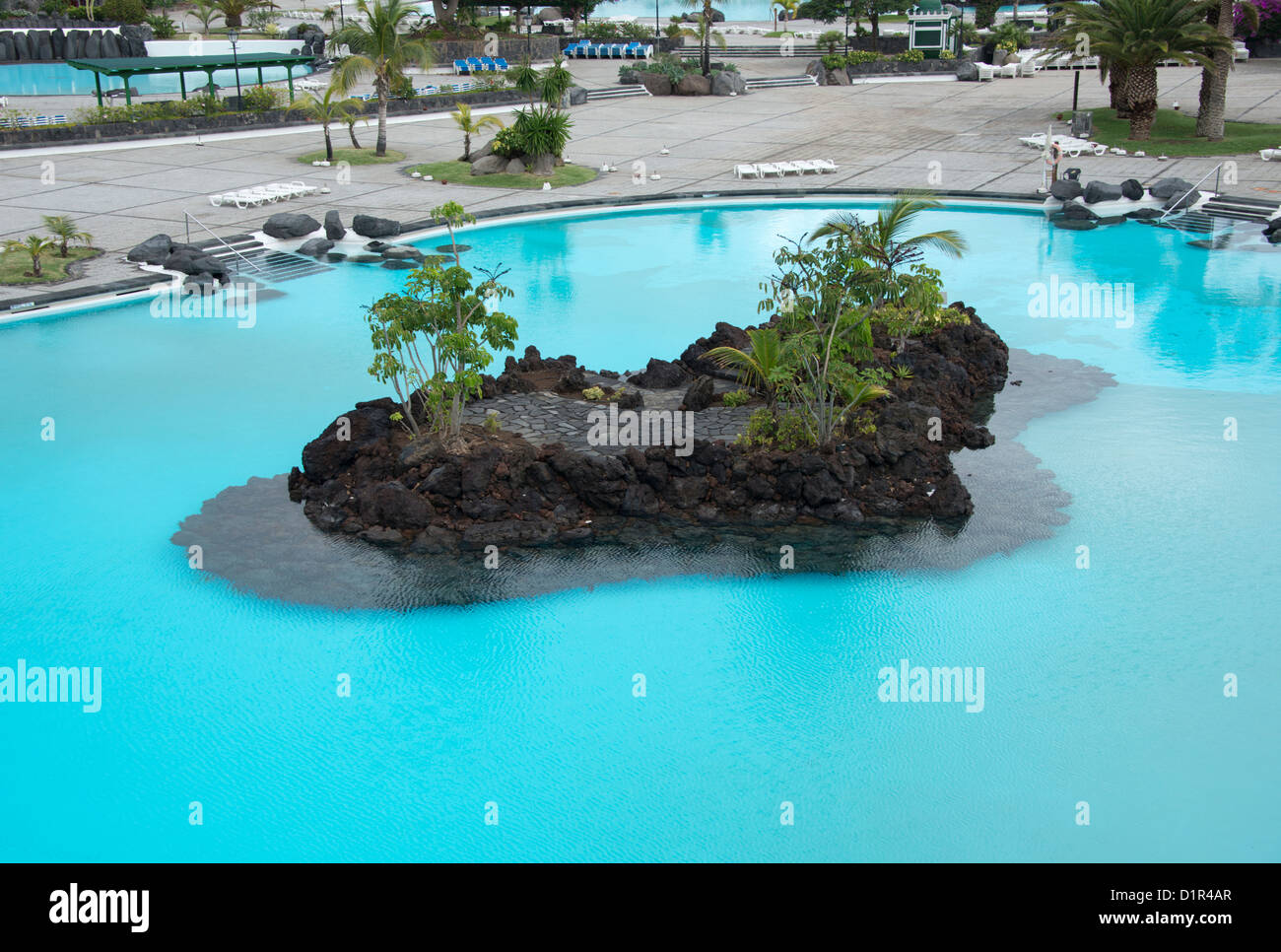 swimming pool with blue water and big rocks Stock Photo - Alamy