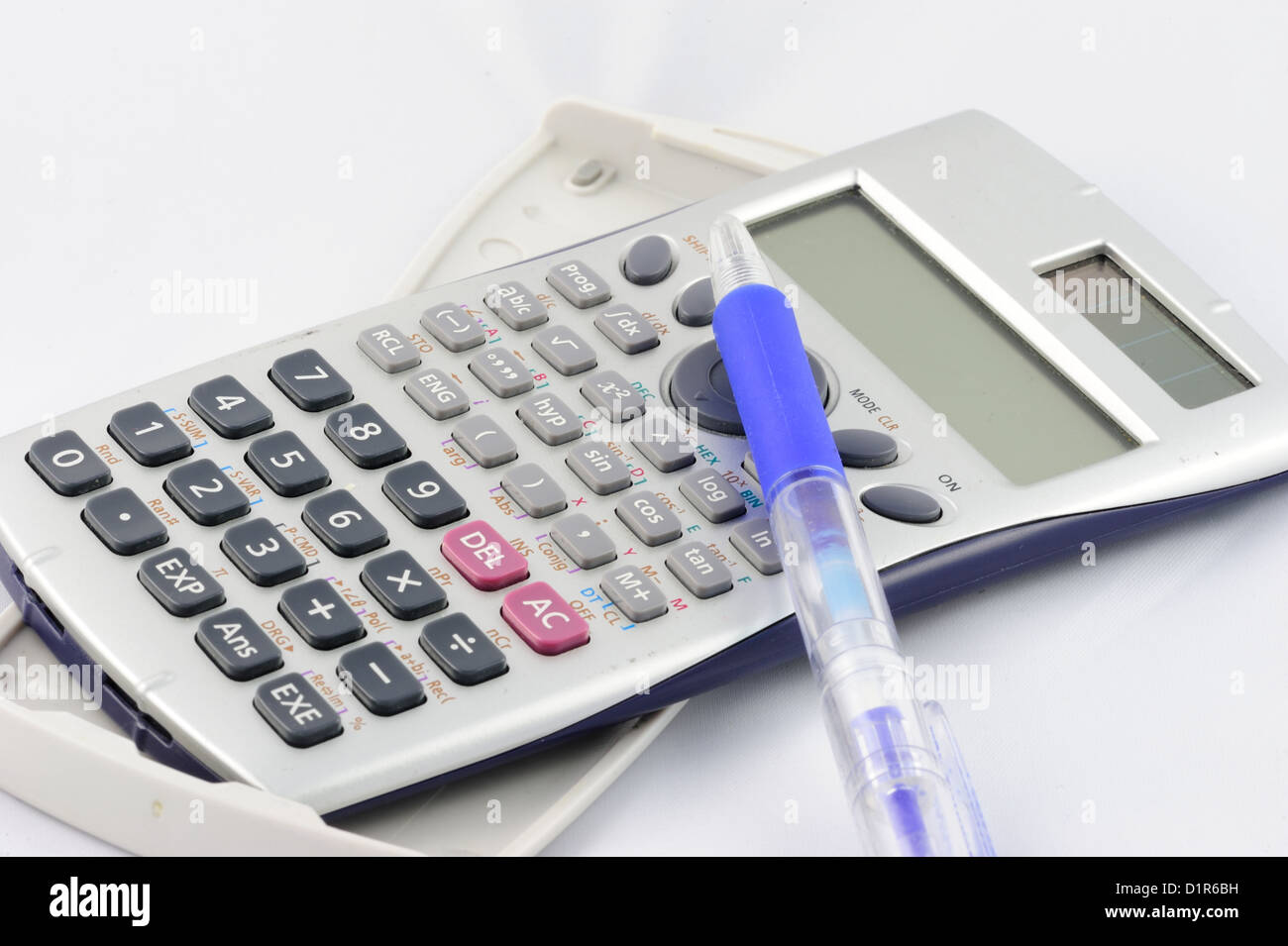 Isolated calculator and pen on white background Stock Photo - Alamy