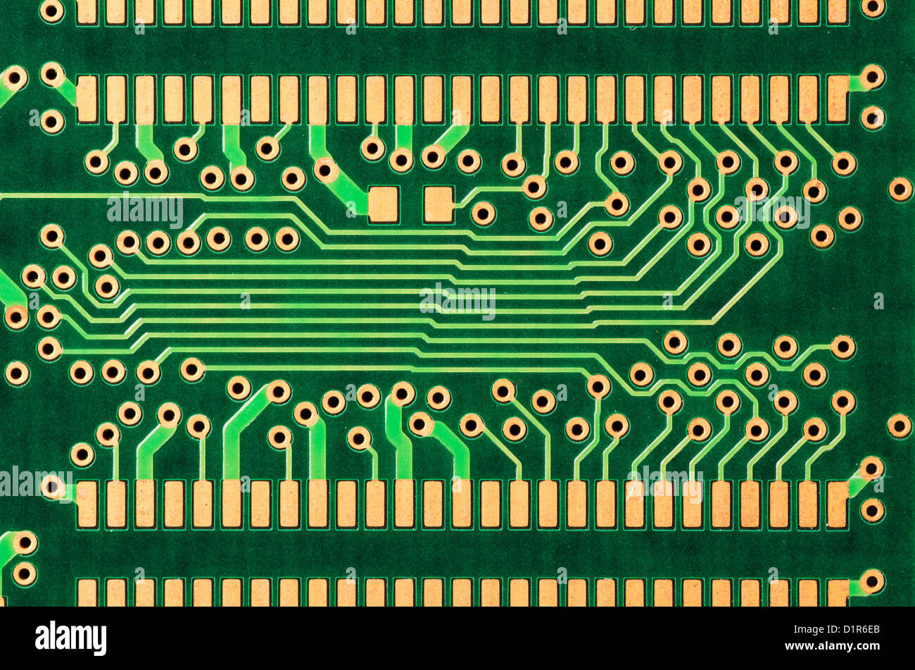 A closeup of a printed circuit board with gold traces Stock Photo - Alamy