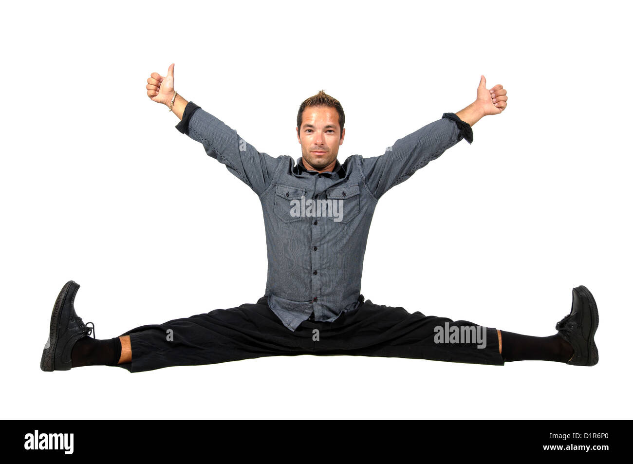 Casual young man doing the splits Stock Photo - Alamy