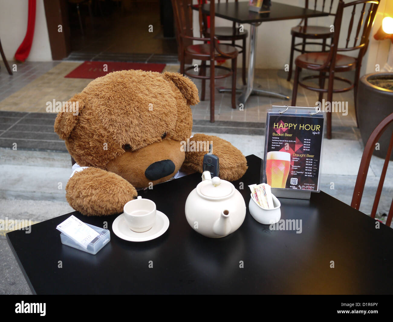 bear sitting dining table Stock Photo - Alamy