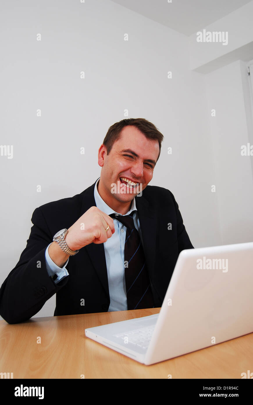 Happy businessman cheering over big win Stock Photo - Alamy