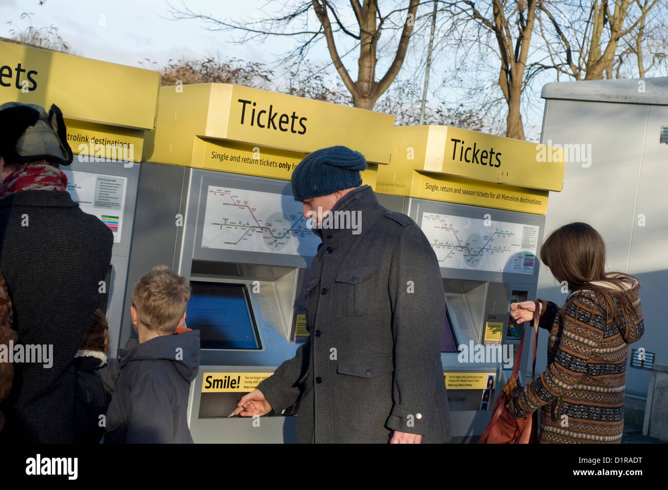 Passengers using a ticket machine for Manchester's Metrolink tram ...