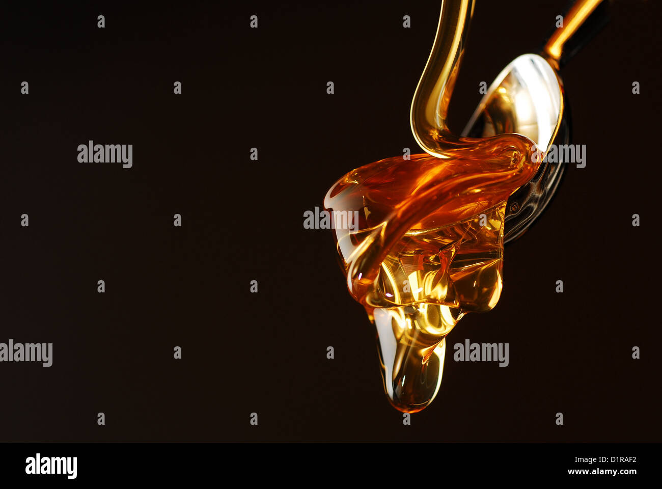 Golden honey dropping stock photo Stock Photo - Alamy