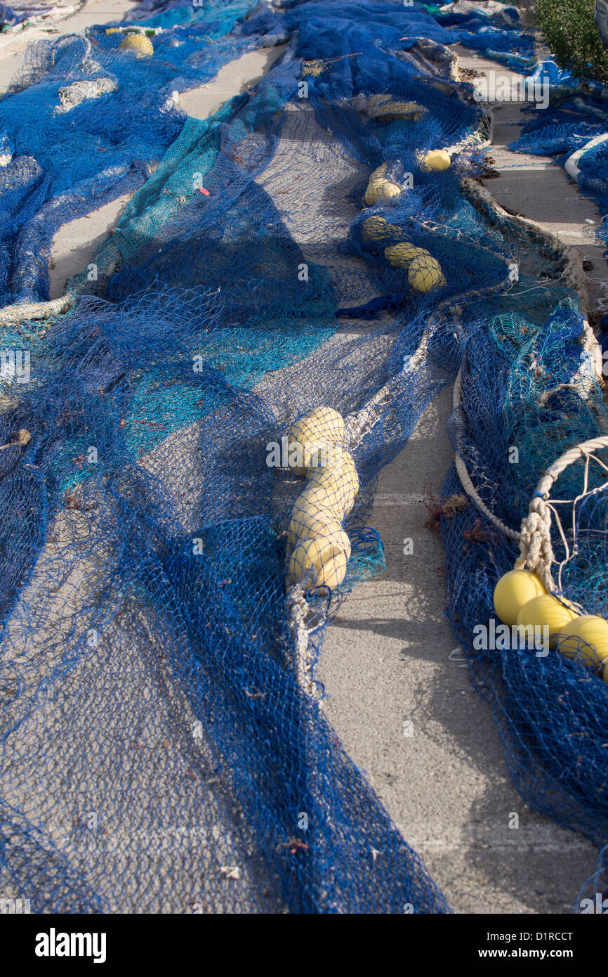 Fishingnet laid out to dry in the sun Stock Photo - Alamy