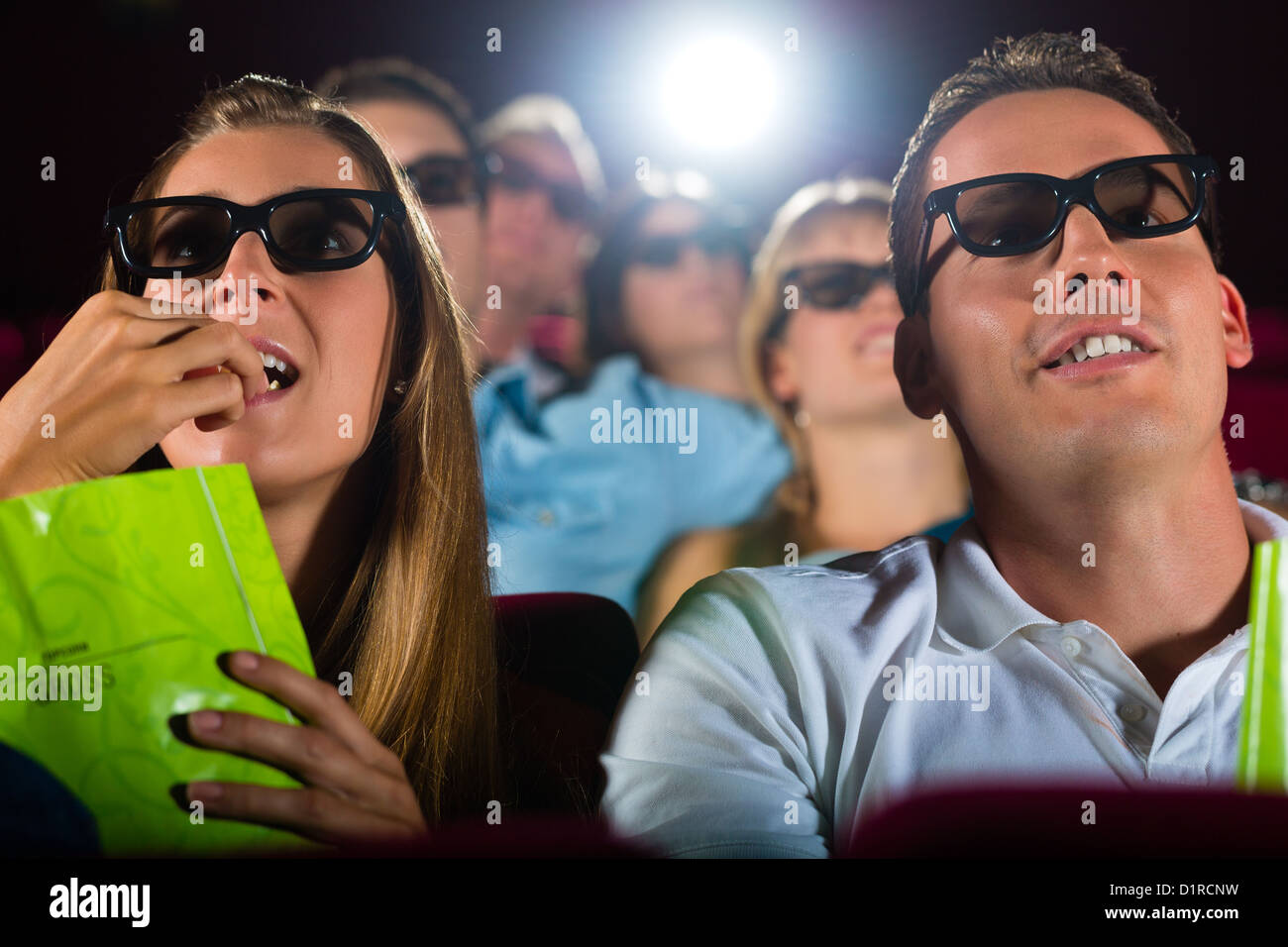 young people watching 3d movie at movie theater Stock Photo - Alamy