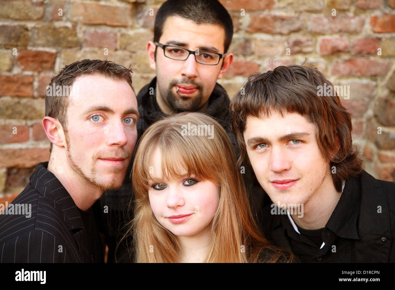Teenage band members, posing for a group shoot to promote their band ...
