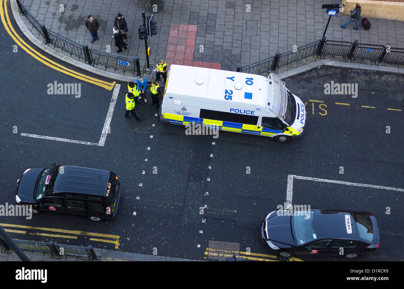 A man being arrested and led to a police van by Northumberland Police ...