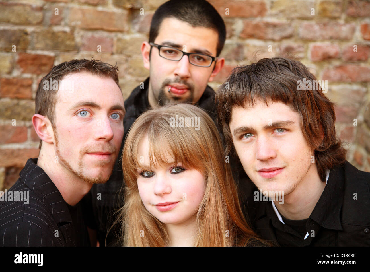 Teenage band members, posing for a group shoot to promote their band ...