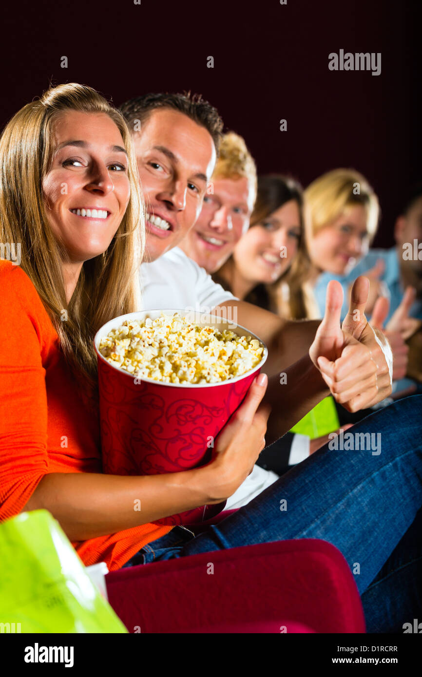 People see a movie in the cinema and have fun they smile at the camera ...