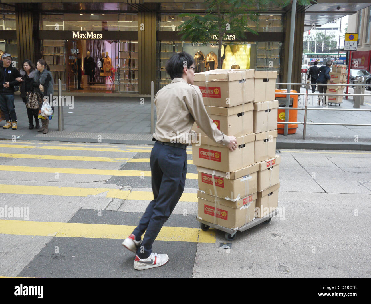 asian man pushing storage boxes across road Stock Photo - Alamy