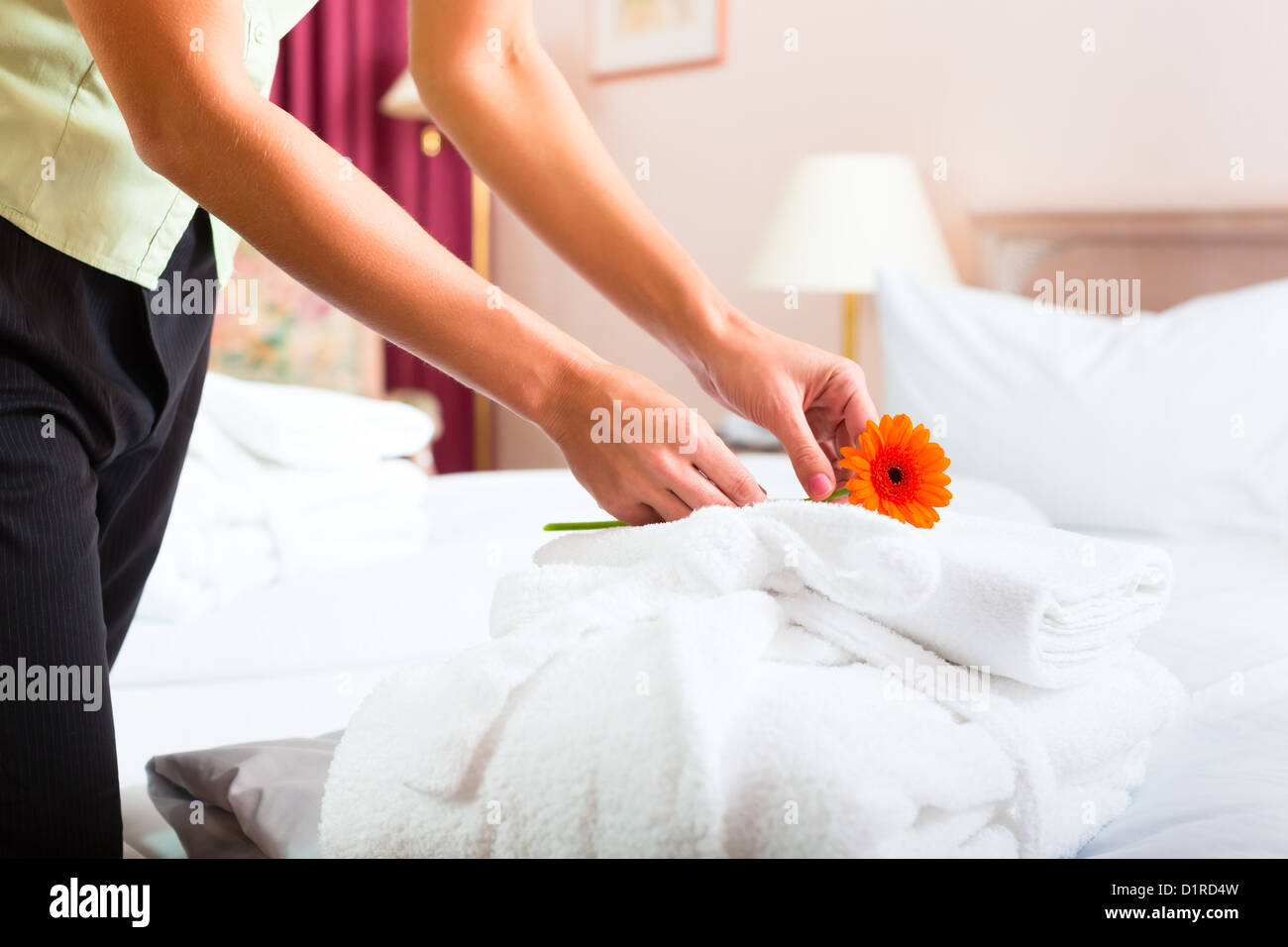 Maid doing room service in hotel, she is making up the beds Stock Photo ...