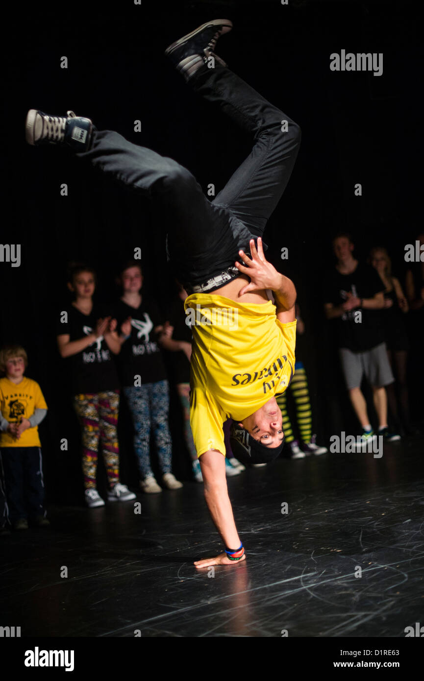 Dancing on one hand: A teenage boy young man person taking part in ...