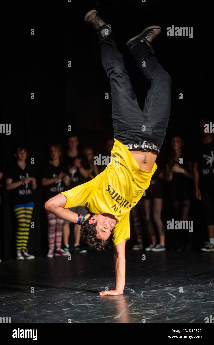 Dancing on one hand: A teenage boy young man person taking part in ...