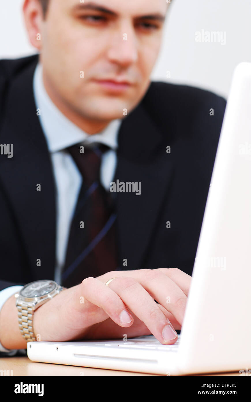 Successful businessman typing on his white computer Stock Photo - Alamy