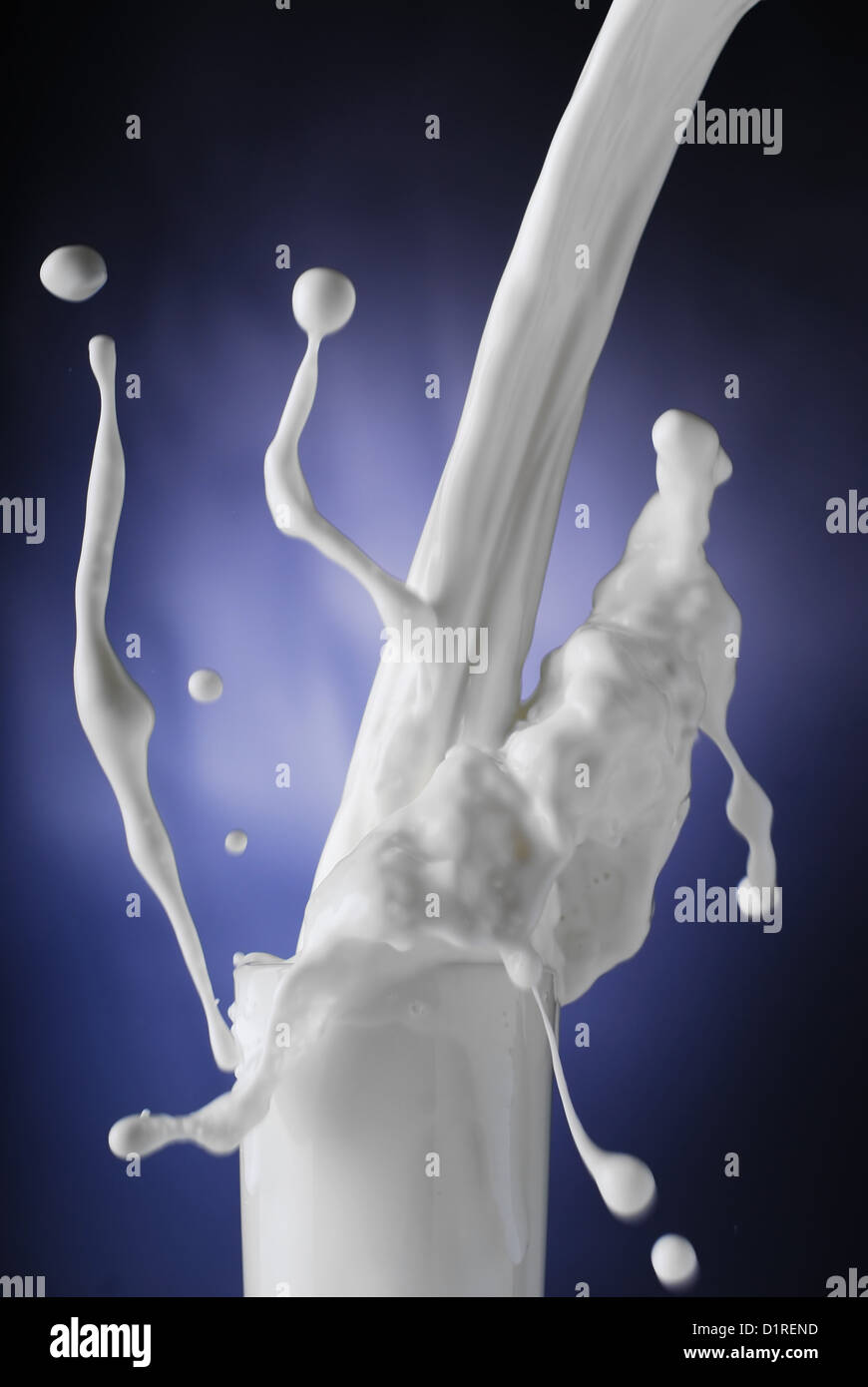 Fresh milk splashing as it is poured in a glass Stock Photo - Alamy