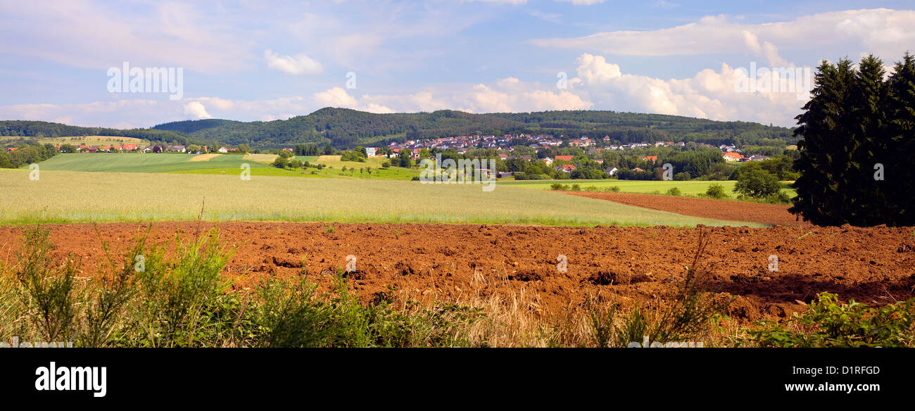 Agriculture landscape with plowed field, in the distance country ...