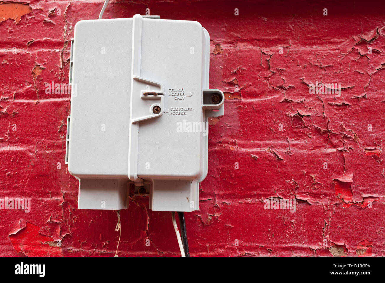 Telephone box on the red brick wall Stock Photo - Alamy
