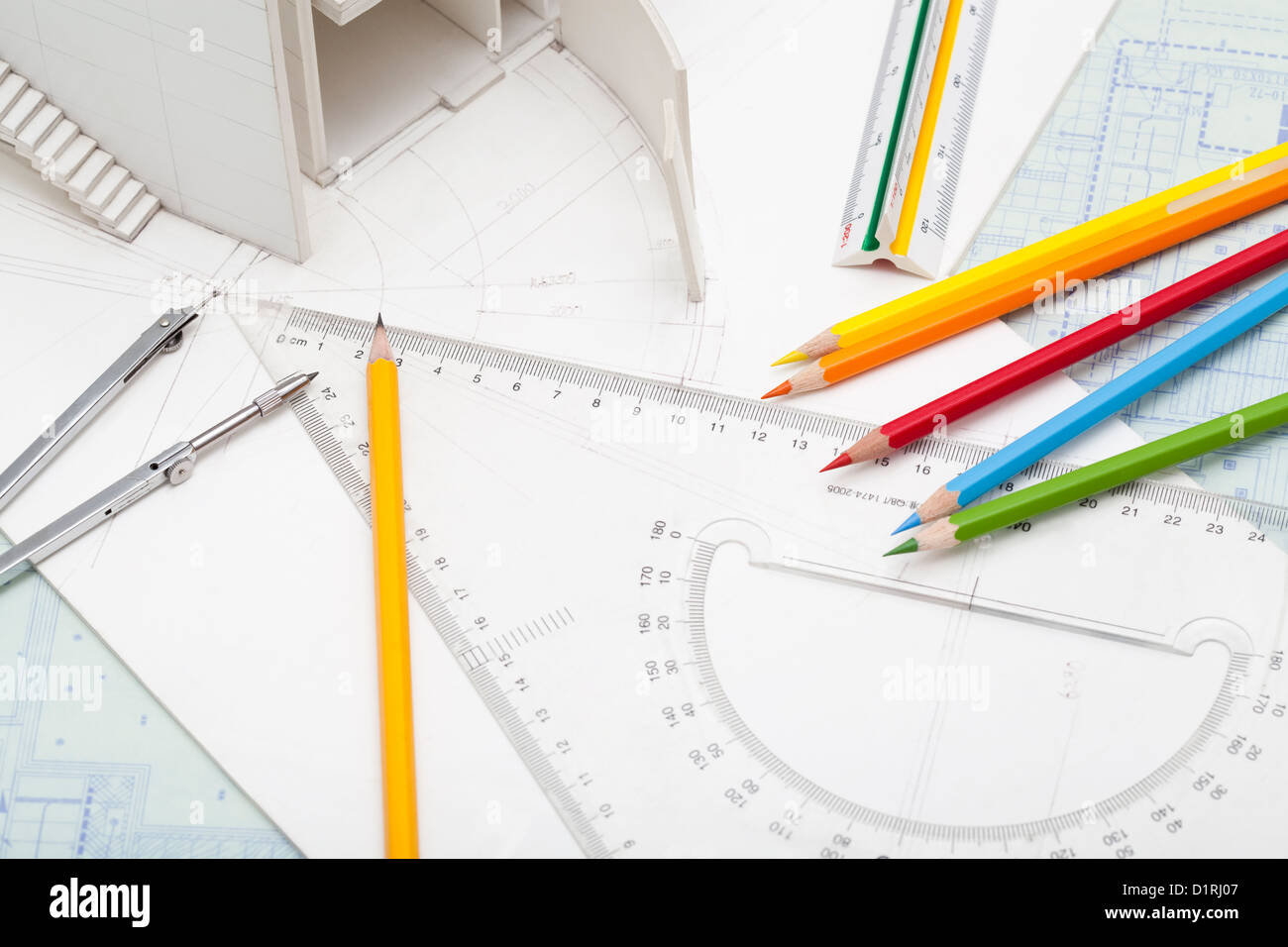 Office stationery and building model in design studio Stock Photo - Alamy