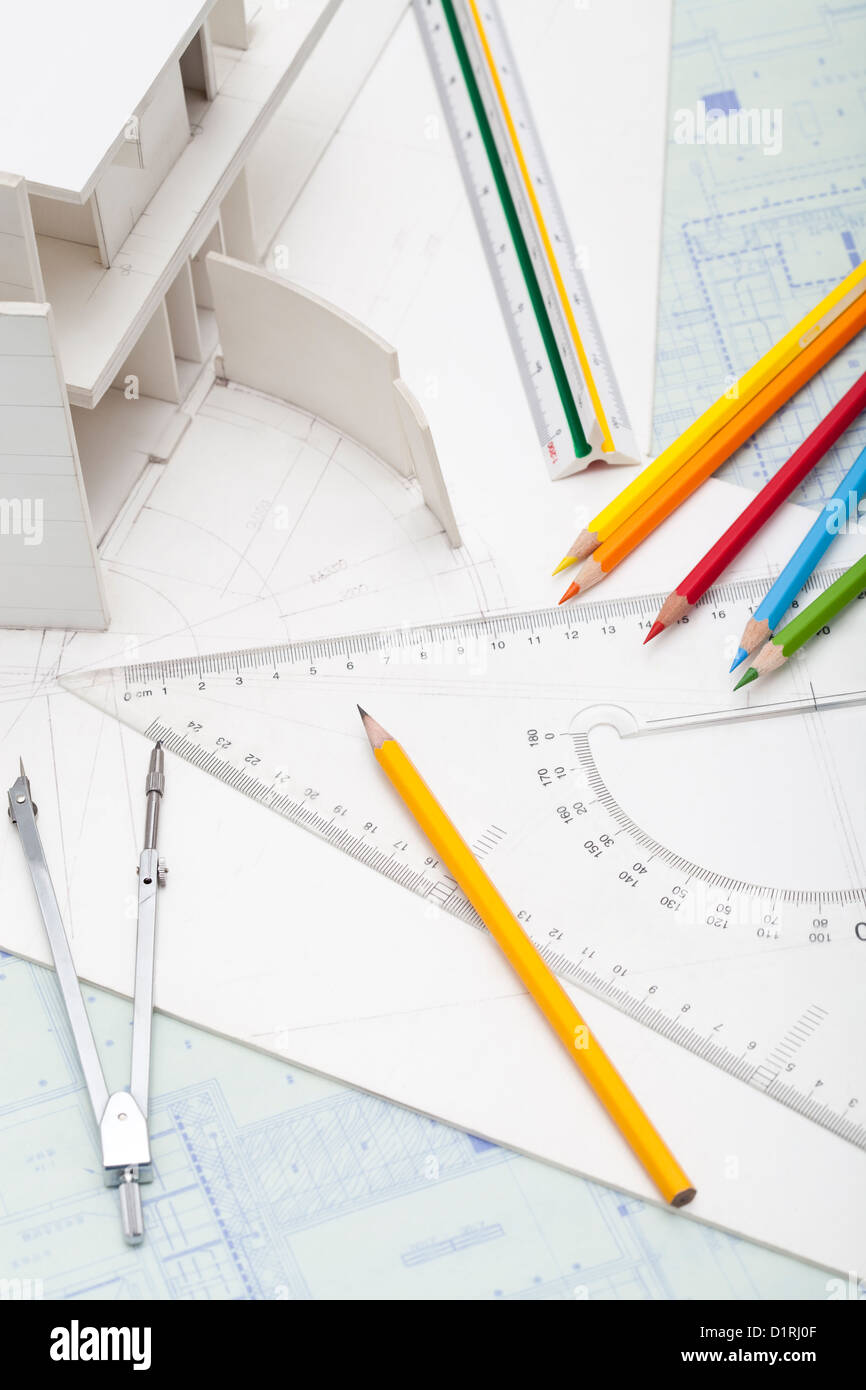 Office stationery and building model in design studio Stock Photo - Alamy