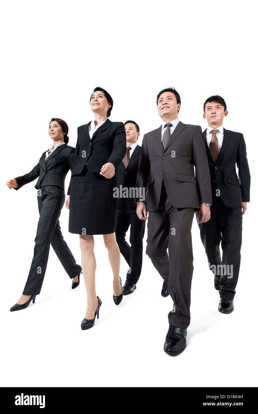 Confident business team walking forward Stock Photo - Alamy