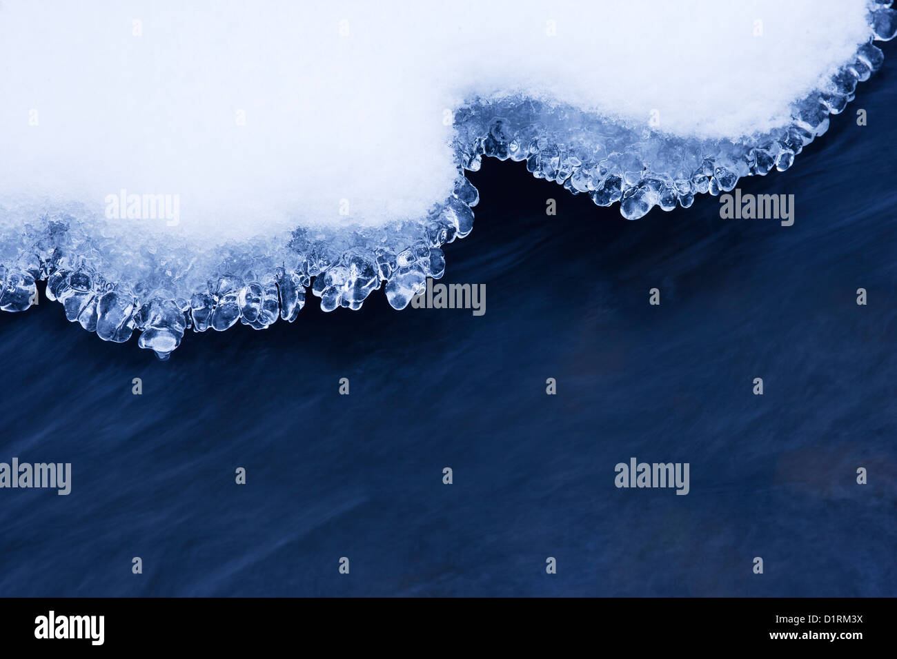 Edge of the ice and flowing water Stock Photo - Alamy