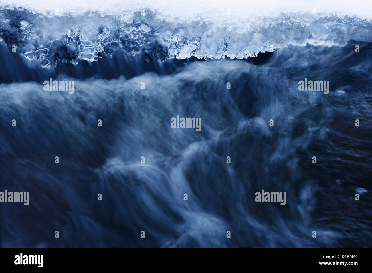 Edge of the ice and flowing water Stock Photo - Alamy