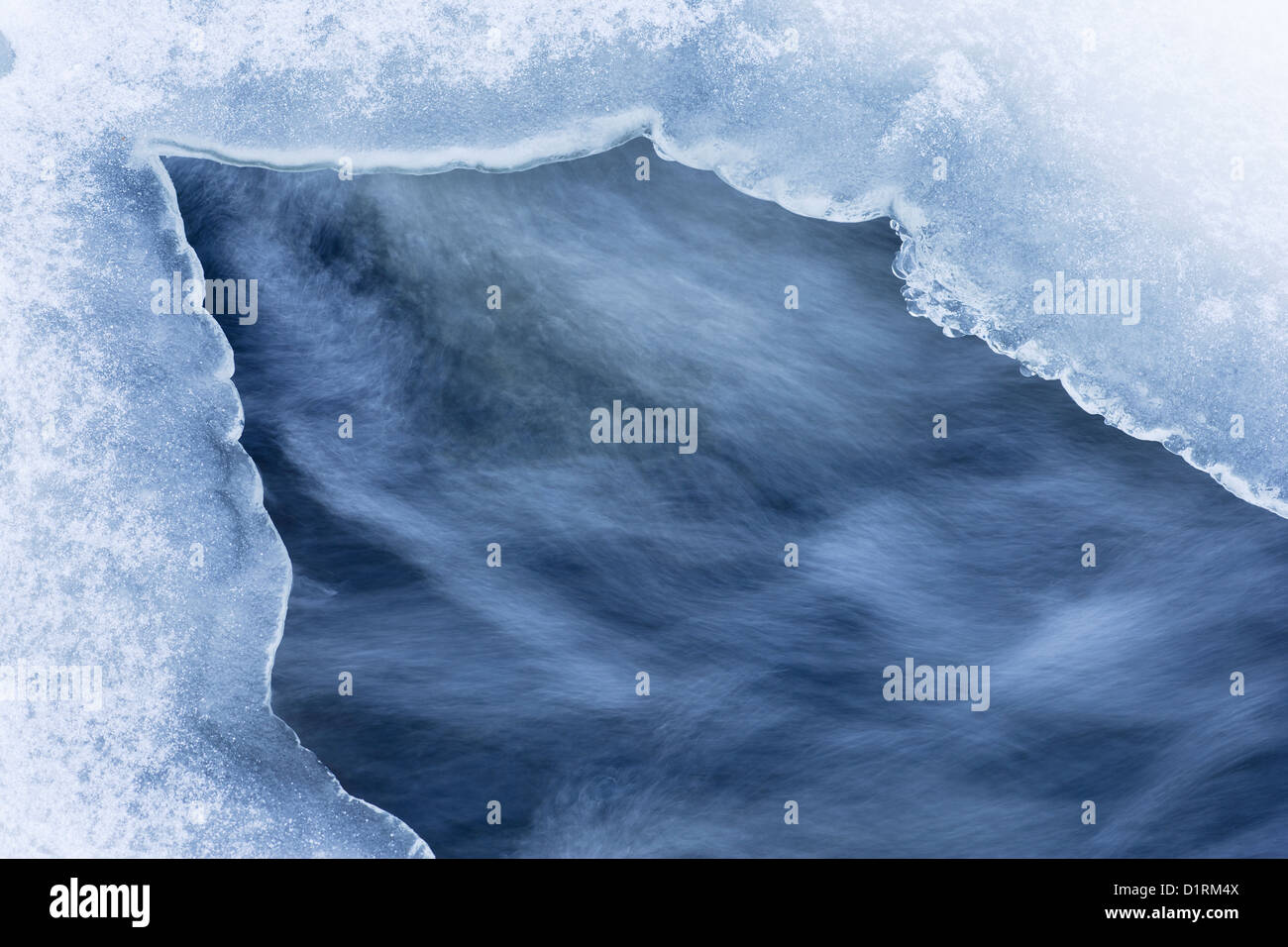 Edge of the ice and flowing water Stock Photo - Alamy