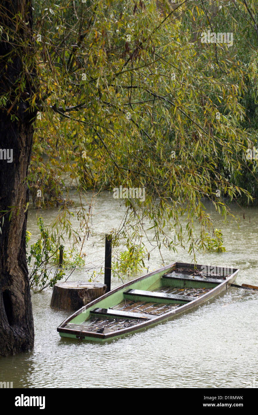 Wooden rowboat under heavy rain Stock Photo - Alamy