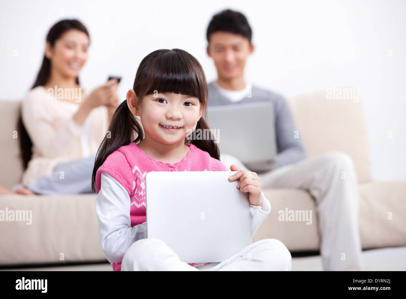 Family using electronic gadgets hi-res stock photography and images - Alamy