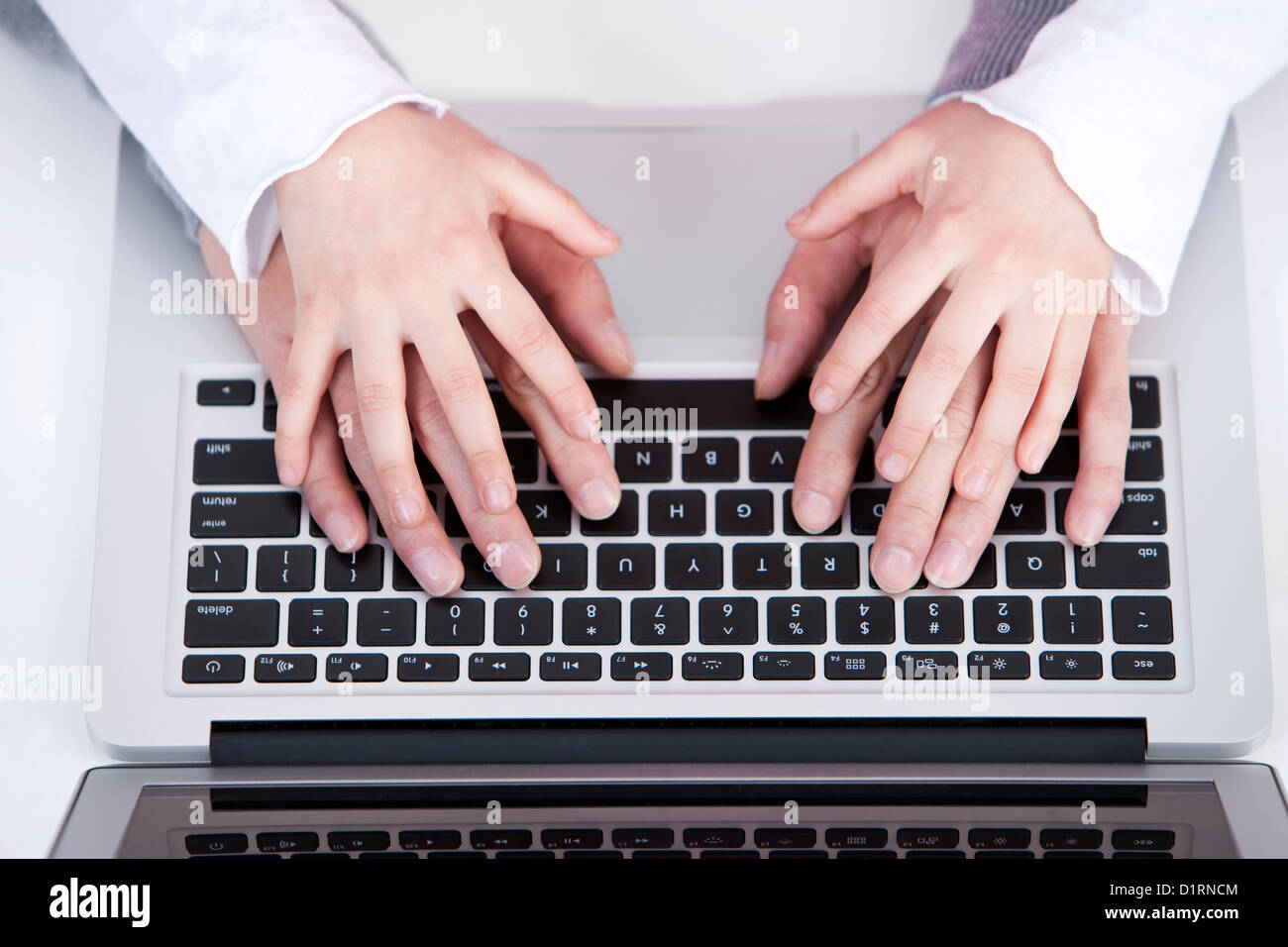 Small hand on big hand, teaching how to use laptop Stock Photo - Alamy
