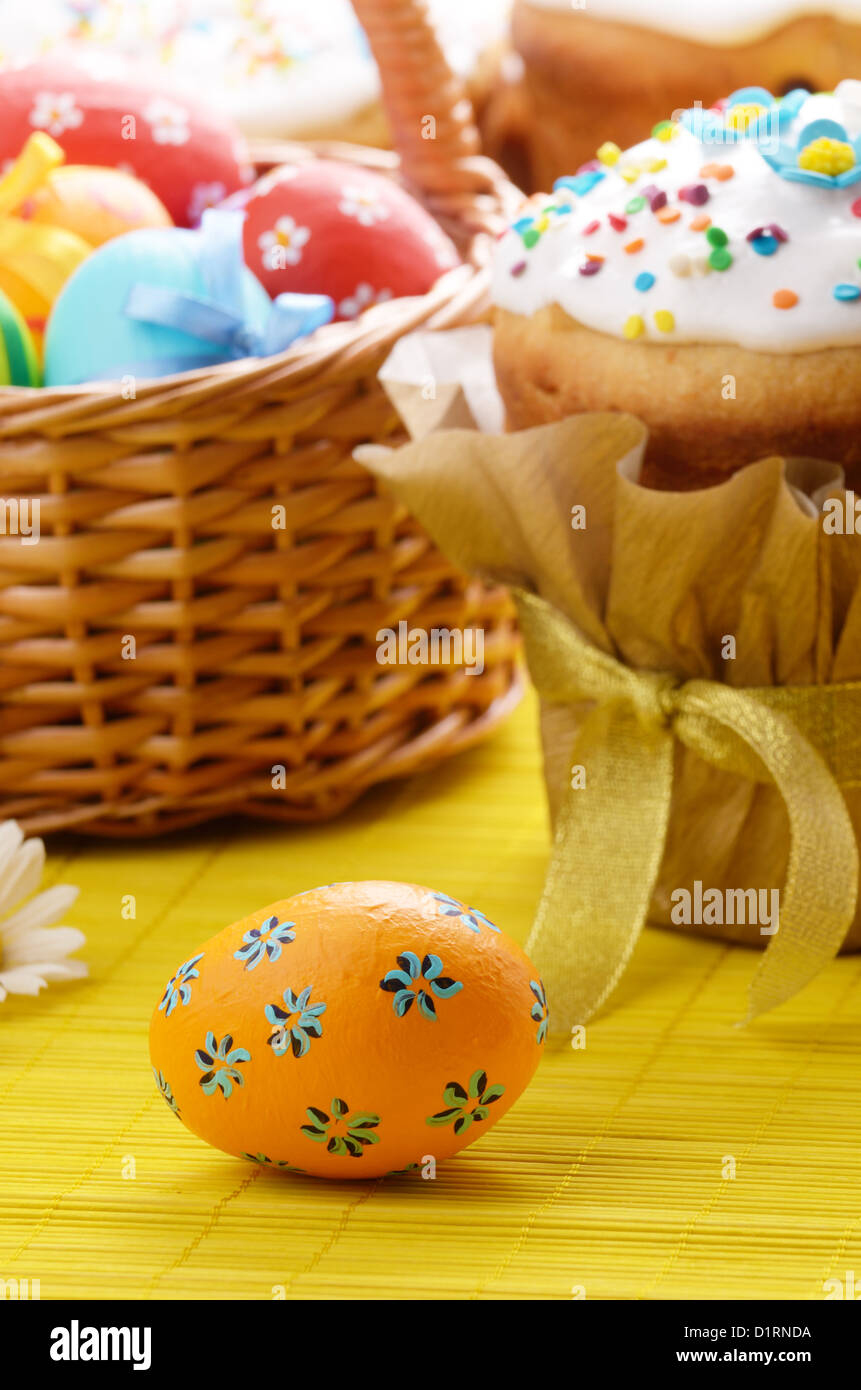 Easter decorations - eggs, cake and basket on the tabletop Stock Photo ...