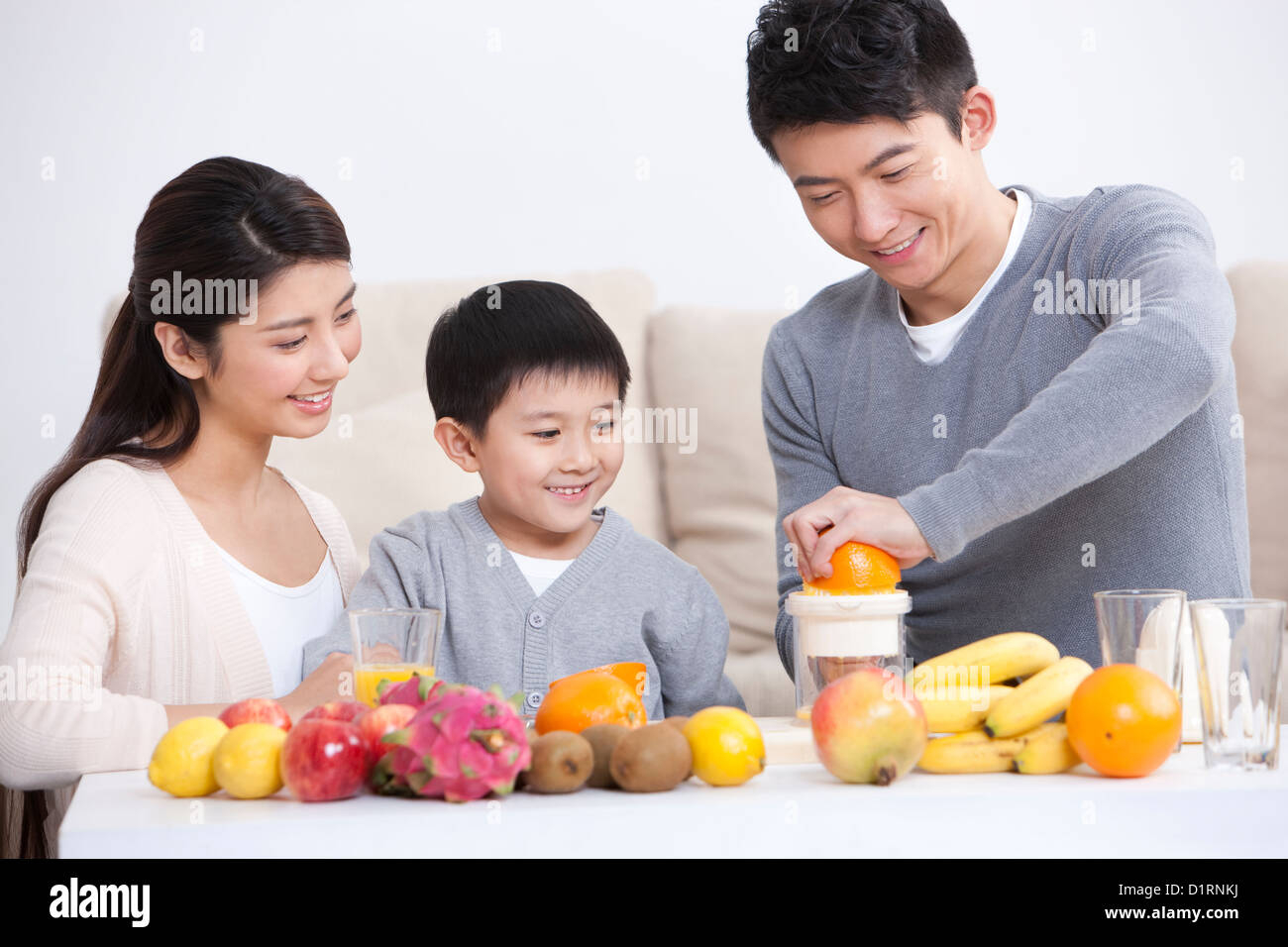 Happy family making juice at home Stock Photo - Alamy