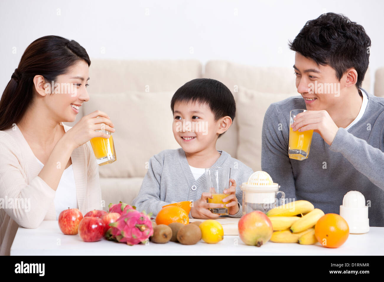 Happy family making juice at home Stock Photo - Alamy