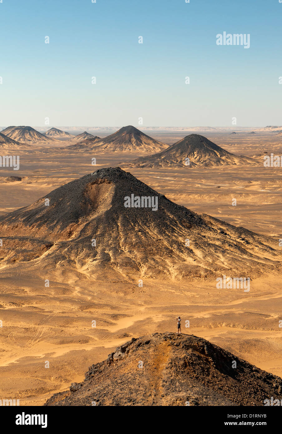 Hiker Climbs Top of Volcano-shaped Pyramid Mountain at Black Desert ...