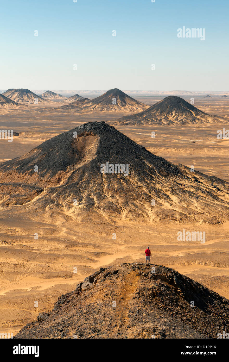 Hiker Climbs Top of Volcano-shaped Pyramid Mountain at Black Desert ...