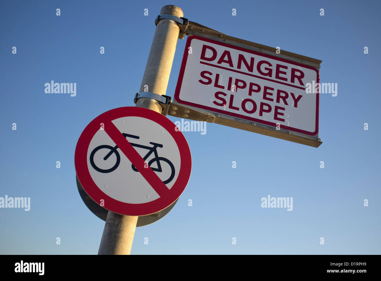 Danger slippery slope sign Stock Photo - Alamy
