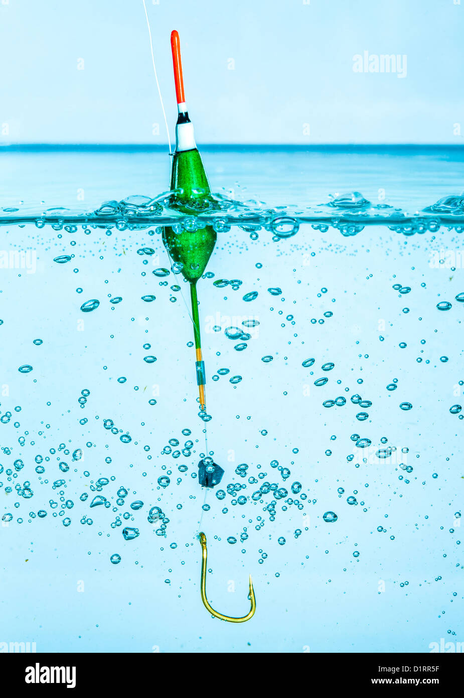 Fishing float against the blue background Stock Photo - Alamy