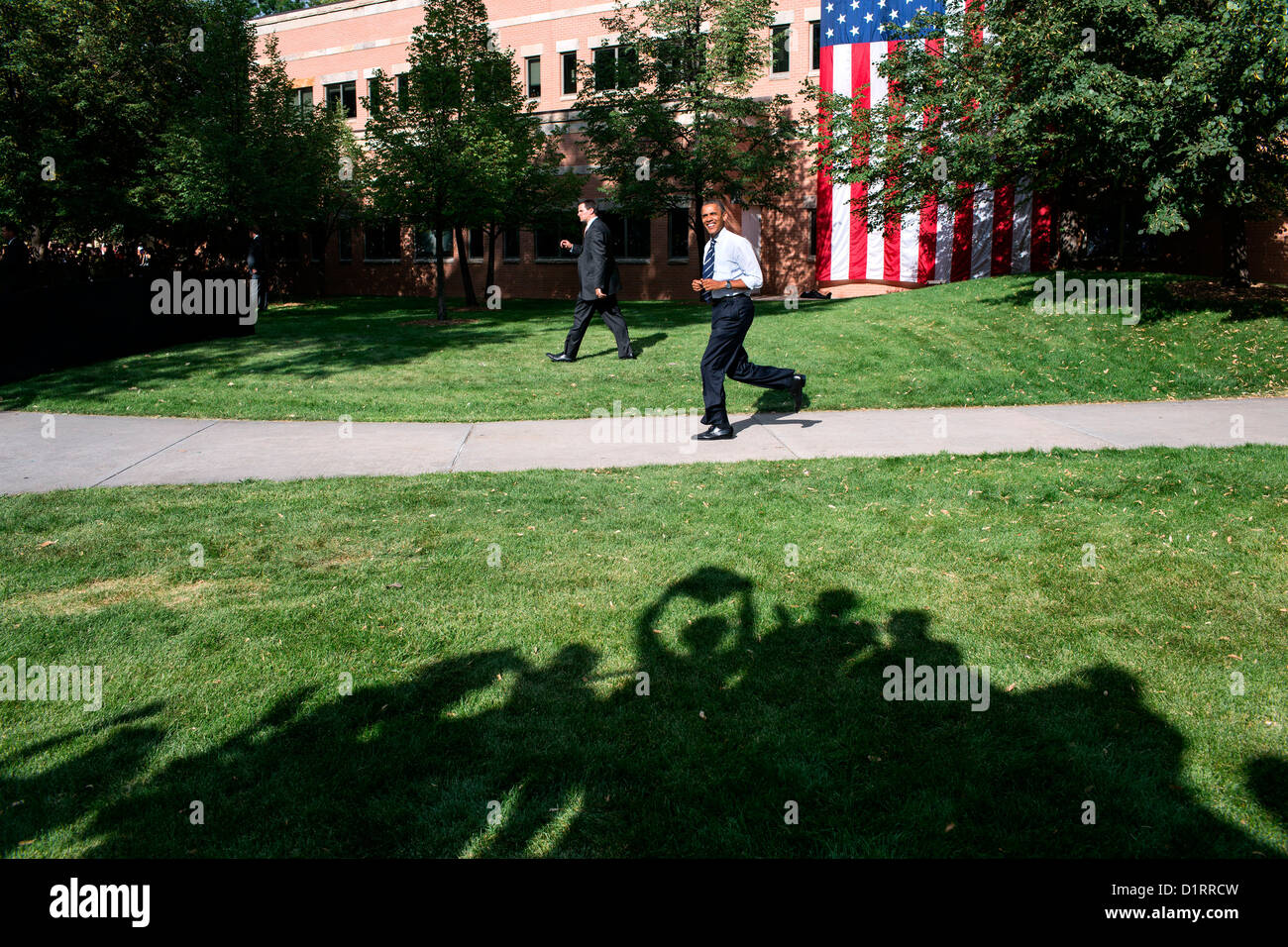 US President Barack Obama smiles as he passes cheering supporters on ...