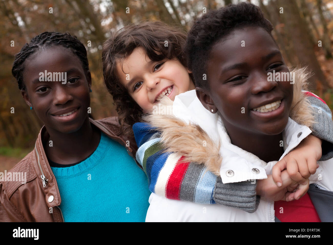 Happy foster children in the forest are having fun Stock Photo - Alamy