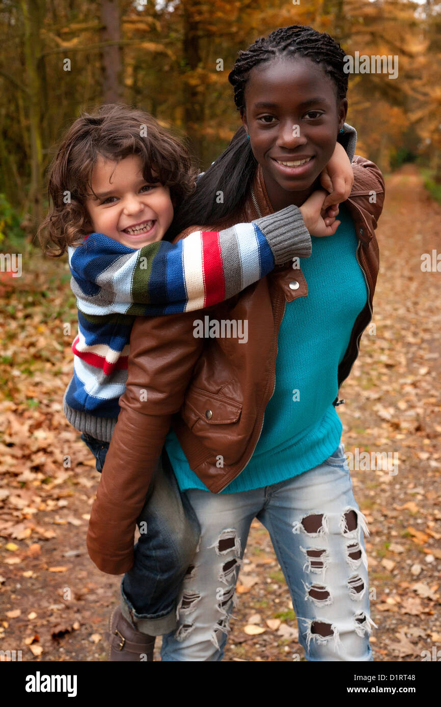Happy foster children in the forest are having fun Stock Photo - Alamy