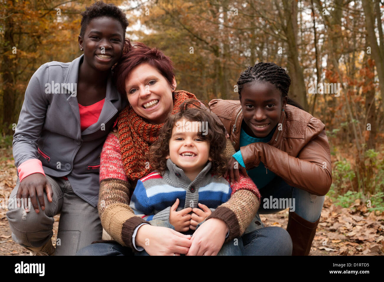 Happy family with foster children in the forest Stock Photo - Alamy