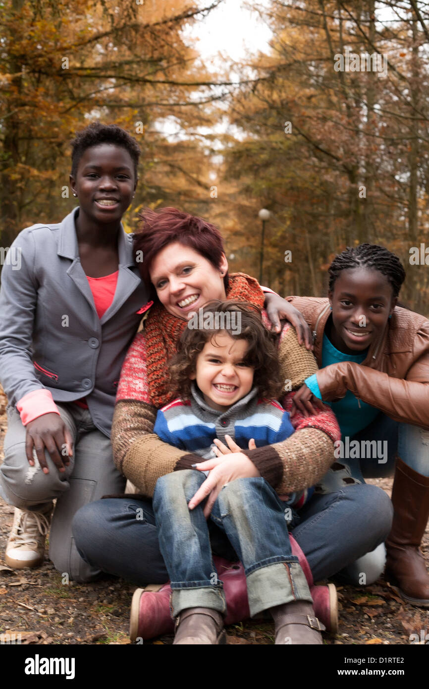 Happy family with foster children in the forest Stock Photo - Alamy
