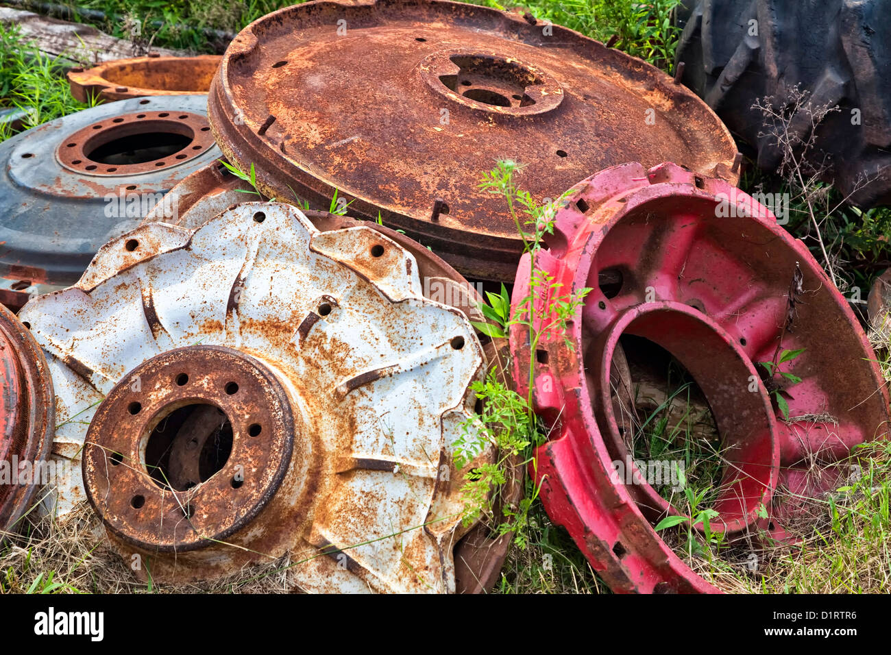 Old and rusted pile of agricultural tire wheel weights in a dump but ...