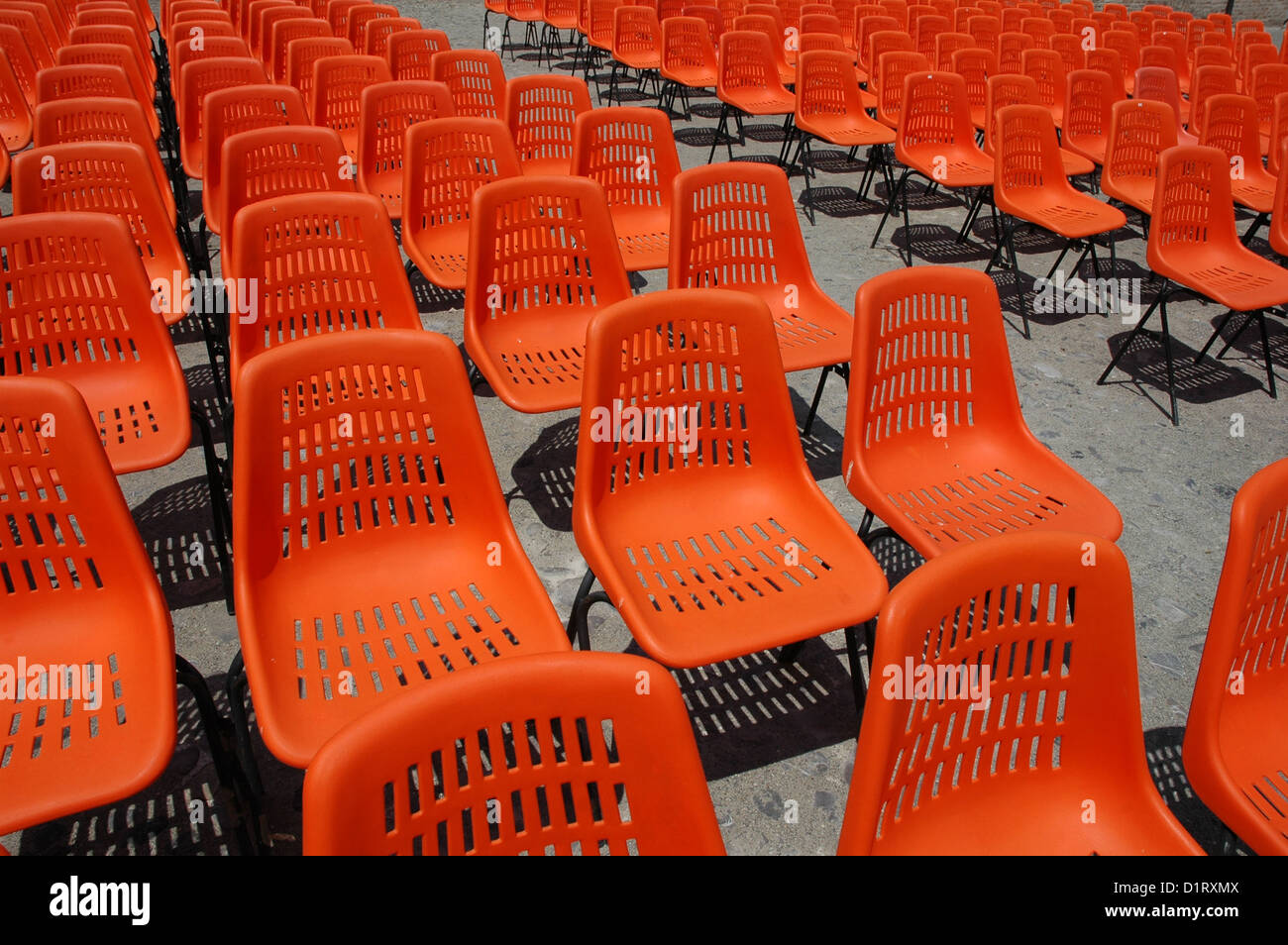 Many red plastic chairs hi-res stock photography and images - Alamy